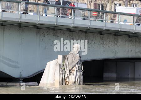 The Zouave statue at the Pont D'Alma bridge stands partially submerged ...