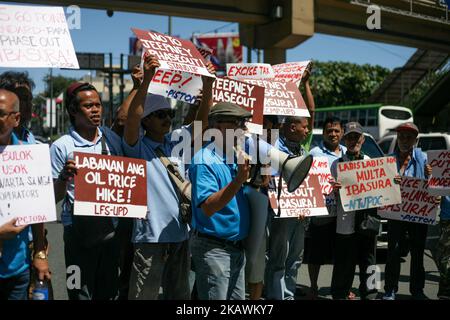 Jeepney drivers belonging to the activist jeepney driver group PISTON ...