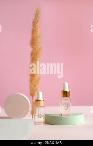 Pipettes with transparent cosmetic liquid or face serum over blue ...