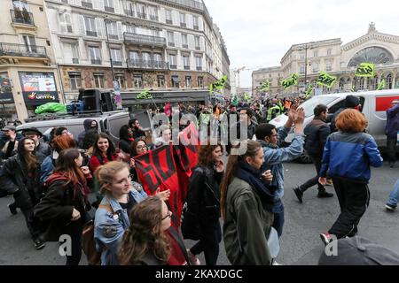 Employees of the French state-owned railway system (SNCF) wear their ...