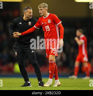 David Brooks of Wales shakes hands with Wayne Hennessey of Wales during ...
