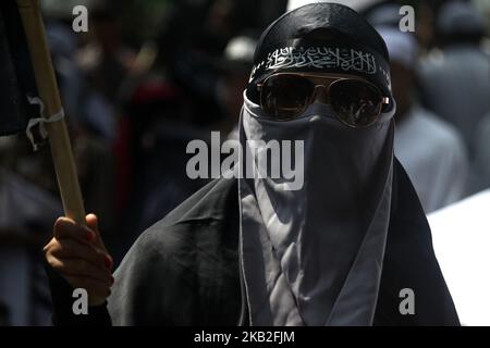 Indonesian Muslims carrying Tawheed flags and other attributes staged ...