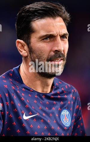 Gianluigi Buffon of Paris Saint-Germain looks on as fans wave flags ...