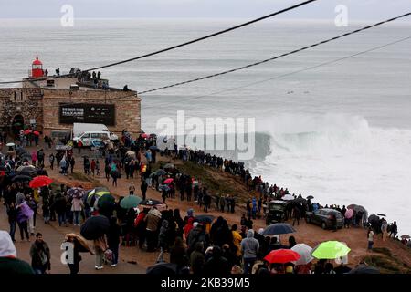 Hundreds of people watch a big wave tow-in surf session at Praia do ...