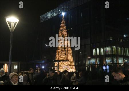 Crowd admiring Christmas tree lights is seen in Gdansk, Poland on 24 ...