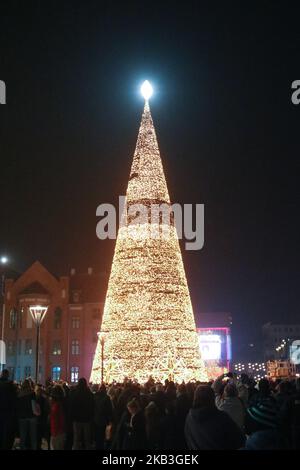 Crowd admiring Christmas tree lights is seen in Gdansk, Poland on 24 ...