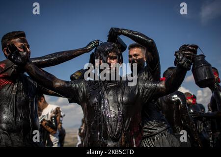 Young people impregnate a friend with black grease during the ...