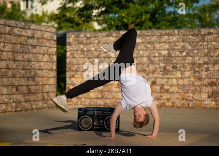 Breakdance dancer.A boy in breakdance position. A dancer in a difficult ...