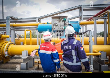 Employees inspect the installation of gas pipelines in the Onshore ...