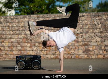 boy in breakdance position, difficult dance position, stands on one ...