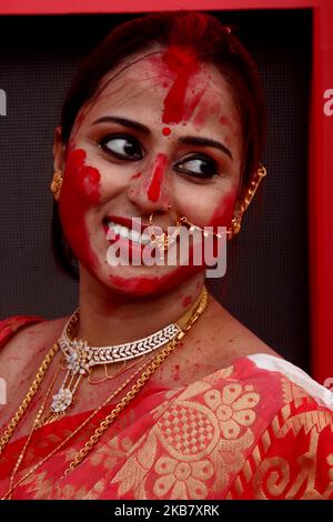 Married women with red vermillion on their faces on top of a truck ...
