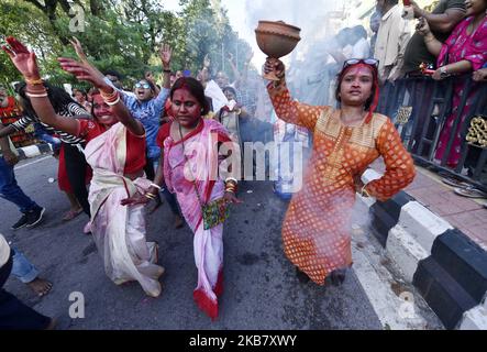 Devotees dance as Hindus immerse an idol of the goddess Durga in the ...
