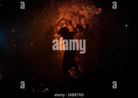 Dozens of Tuban village youths throwing coconut husks full of fire to ...