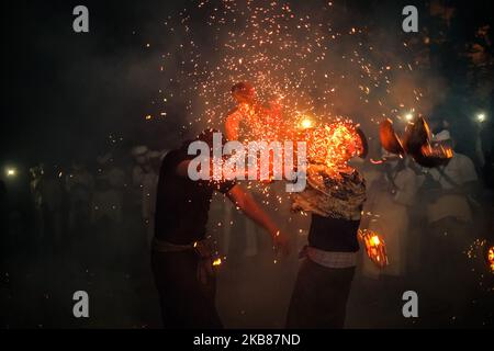 Dozens of Tuban village youths throwing coconut husks full of fire to ...