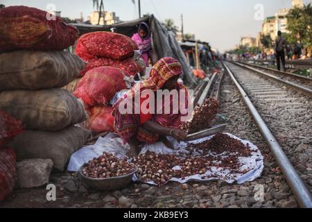 Vendor seen preparing semi-rotten onion to sell in a market of a low ...