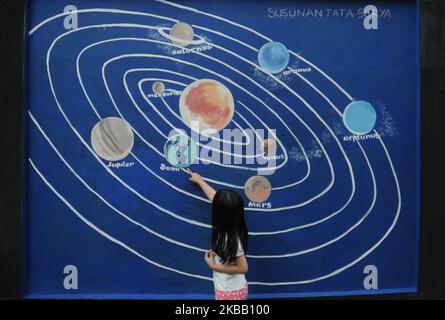 Children with Parents see education Graffiti themed walls in a narrow ...