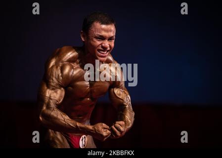 Male bodybuilding athlete poses on stage during the 46th State and ...