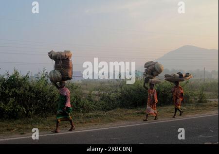 Villagers are seen inside the Balimela reservor as they moves out by ...