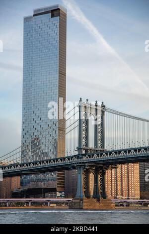 Column of the Brooklyn Bridge seen from East River in New York City ...