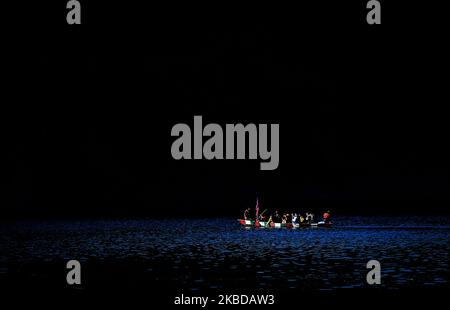 A group of Nepalese people sailing boat on Kupinde Lake at Salayan ...