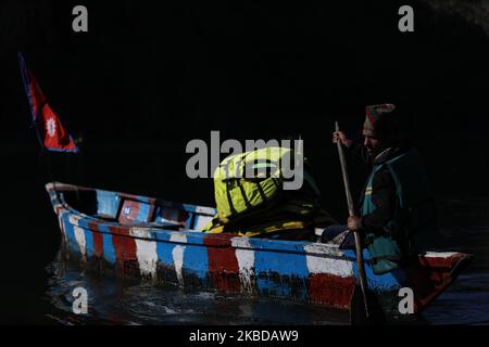 A group of Nepalese people sailing boat on Kupinde Lake at Salayan ...