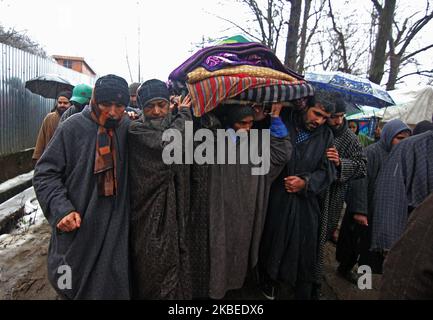 Bracing snow and rainfall villagers carry the dead body of top rebel ...