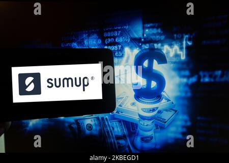 The logo of SumUp is seen on a screen of a smartphone next to an ...