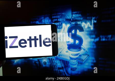 The logo of iZettle is seen on a screen of a smartphone next to an ...
