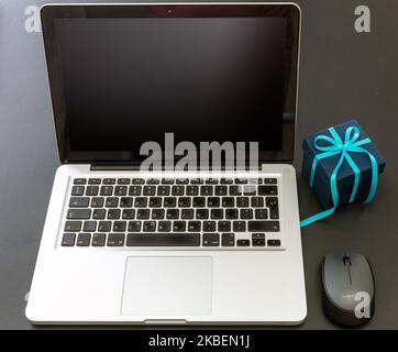 Cyber Monday Sale. Gift box with ribbon bow and computer laptop on ...