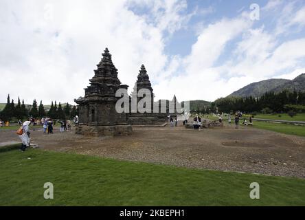 Tourists are in the Arjuna Temple complex, a Hindu temple building ...
