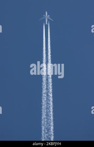 Jet stream or contrails on a blue sky with white clouds, left by ...