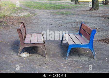 Two wooden benches facing each other with a trash can in between Stock ...