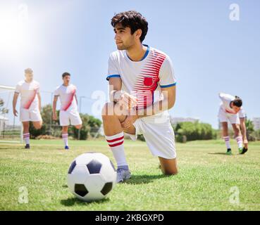 Football, team sports and stretching legs on field for fitness ...