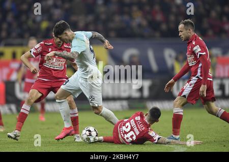 Dennis Man of FCSB in action against Ronaldo Deaconu of SEPSI OSK ...