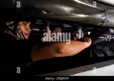 Police officers secure the suspect outside a mall in San Juan City ...