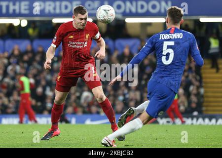 James Milner of Liverpool heading the ball past Jorginho of Chelsea ...