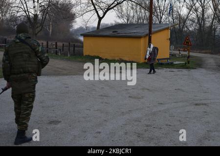 A woman from Cameroon is apprehended by Greek army patrol as she ...