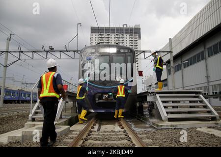 Officers clean the MRT Jakarta train interiors with disinfectant liquid ...