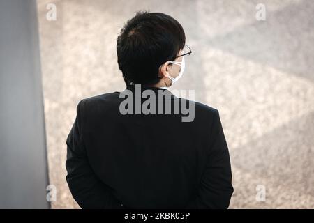 An employee wearing protective mask at Helsinki Airport in Vantaa ...