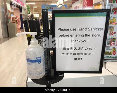 Sign asking customers to use hand sanitizer before entering a store ...