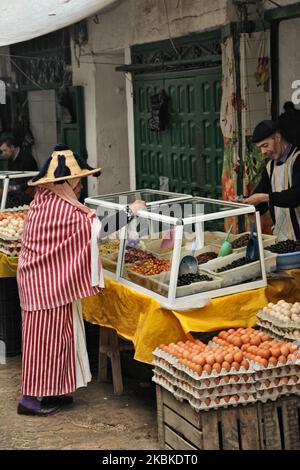 A woman buys eggs at a market in Caracas, Venezuela, Sunday, Jan. 4 ...