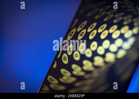 Bitcoin logos are seen on an iPhone 11 Pro Max in this illustration ...