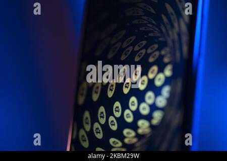 Bitcoin logos are seen on an iPhone 11 Pro Max in this illustration ...