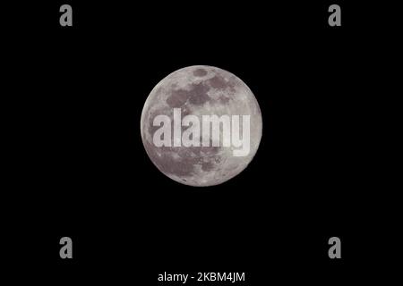 The full moon is pictured from Rome, Italy, early on April 7, 2020 ...