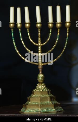 The menorah lamp seen in a closed restaurant's window in Kazimierz, a ...