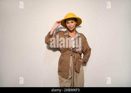 cheerful archaeologist in brown jacket and makeup smiling at camera on ...