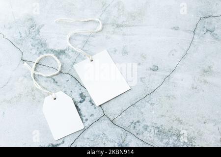 Rectangle white tag mockup with white cord, close up. Blank paper ...