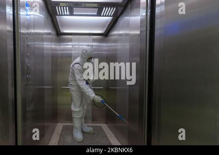 Palestinian health staffs, wearing protective gear, sterilize a room at ...