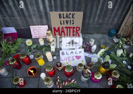 Lit candles, flowers and signs are seen in front of the US embassy in ...