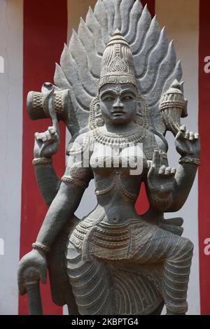 Statue of a female guardian deity flanking the entrance of the Arul ...